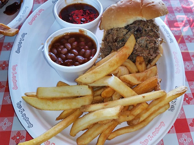 The pulled pork sandwich – where smoke-kissed meat meets soft bun in a relationship so perfect it should have its own reality show.