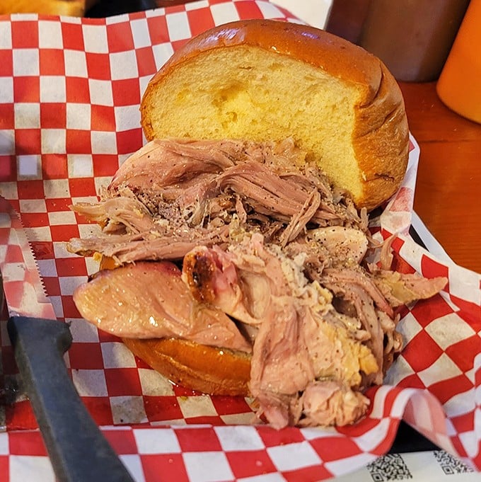 When pulled pork is this tender and smoke-kissed, the humble sandwich becomes a work of art worthy of its red-checkered frame.