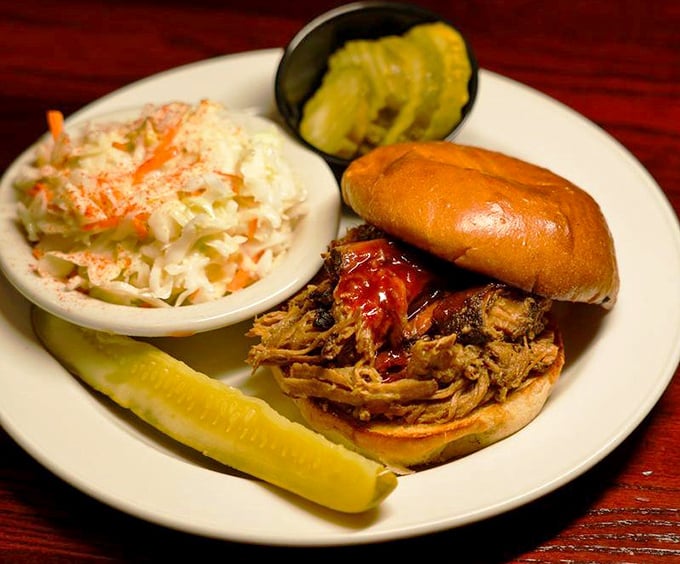 This pulled pork sandwich isn't messing around—tender meat that clearly took its sweet time becoming this delicious, with slaw for that perfect textural counterpoint.