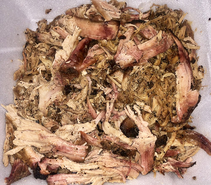 Pulled pork that doesn't just fall apart—it practically introduces itself to each taste bud individually, like a friendly neighbor.