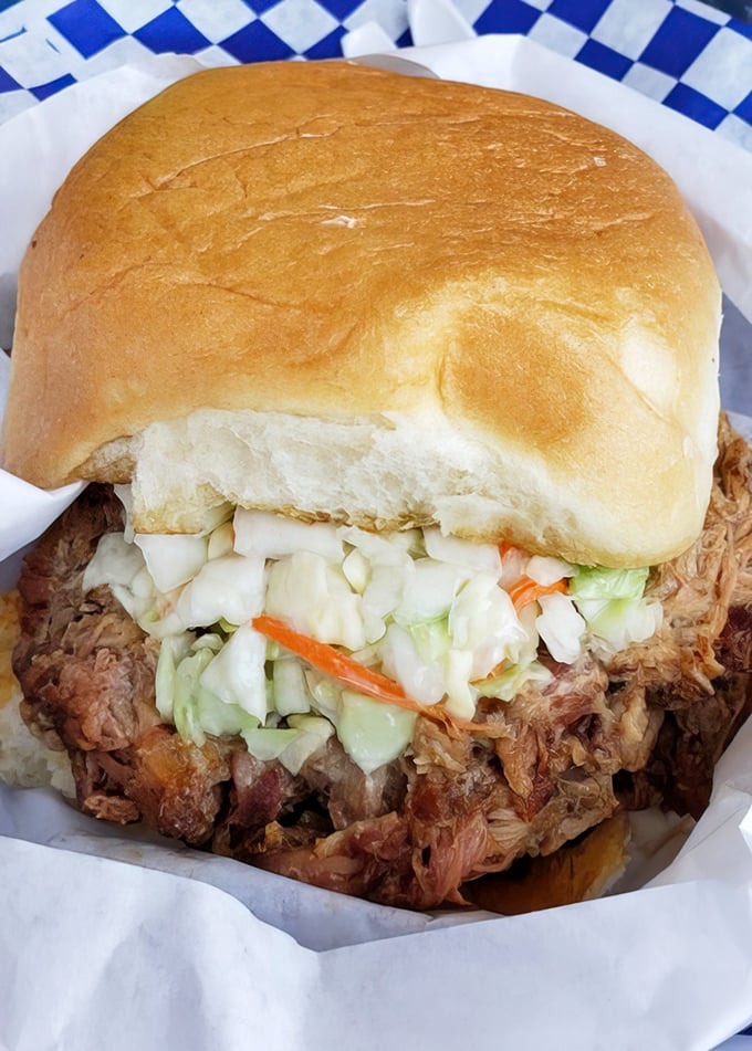 A pulled pork sandwich that doesn't need fancy tricks – just honest smoke, pillowy bun, and that perfect slaw-to-meat ratio.