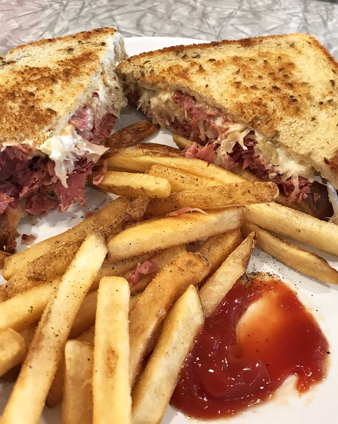 The Reuben sandwich—where sauerkraut, corned beef, and melted cheese perform a harmonious dance that makes you forget you're in Ohio, not New York.
