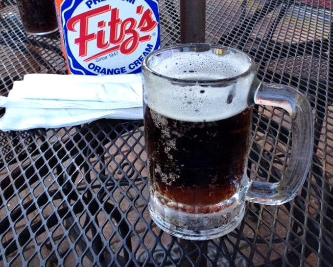 The star of the show in its natural habitat—a frosty mug of house-made root beer that makes the mass-produced stuff taste like liquid disappointment.