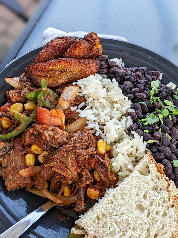 Ropa Vieja that transports you straight to Havana – tender shredded beef swimming in a sea of vibrant vegetables with plantains standing guard.