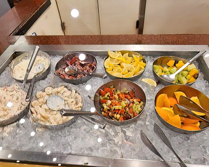 The cold bar's colorful array of seafood salads and fresh fruit offers a refreshing counterpoint to all that warm, buttery indulgence.