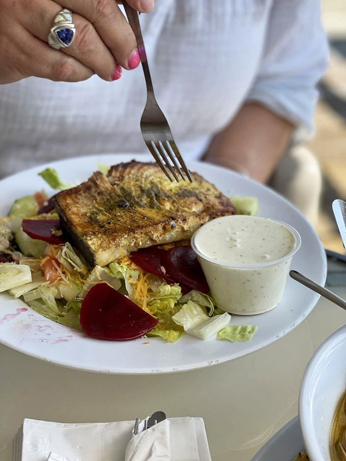 Ocean meets garden in perfect harmony. This grilled fish salad proves healthy eating doesn't mean sacrificing flavor—especially with that house-made dressing.