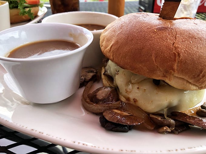 This isn't just a burger—it's architecture. Melted cheese cascading over mushrooms with a side of au jus for dunking? That's not lunch, that's therapy.