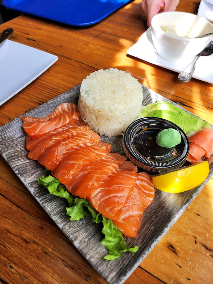 Salmon sashimi arranged like edible artwork. Each glistening slice promises the clean, pure flavor that makes raw fish enthusiasts close their eyes in silent appreciation.
