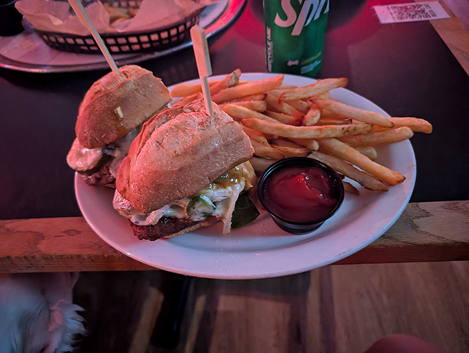 A sandwich that requires both hands and your full attention. Those golden fries aren't just a side—they're co-stars in this delicious production.