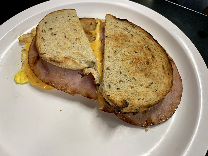 The humble breakfast sandwich elevated to art form—where thick-cut ham and melty cheese create morning magic between toasted bread.