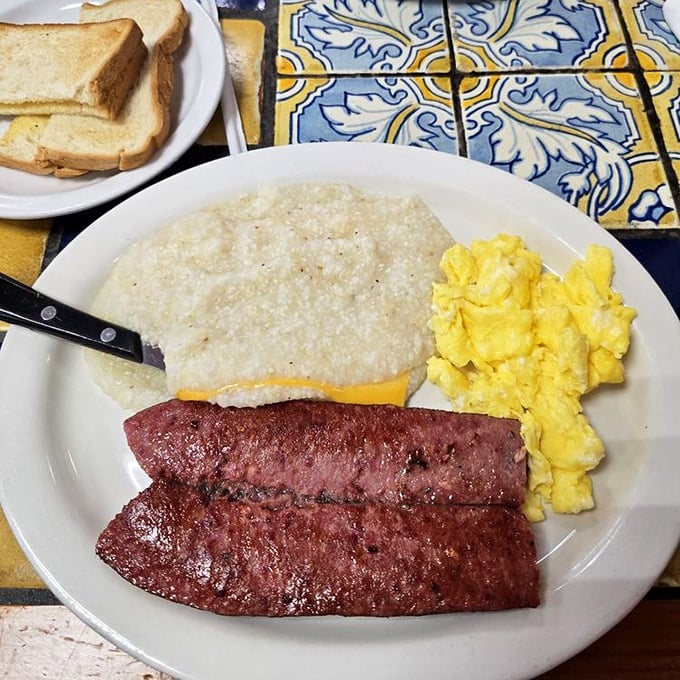 This isn't just breakfast—it's performance art. Spicy sausage links, sunny eggs, and grits that would make any Southerner nod in approval.