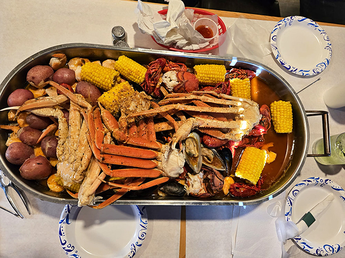 The seafood motherlode—crab legs, corn, potatoes, and more—arranged like Neptune's personal feast. Bring reinforcements or prepare for delicious leftovers.