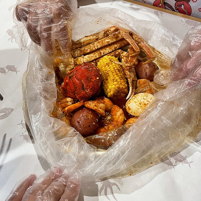 The seafood boil arrives like a treasure chest—crab legs, corn, potatoes, and shrimp mingling in spiced harmony. Plastic gloves required, dignity optional.