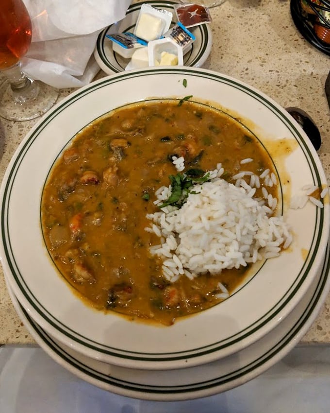 This seafood gumbo isn't just a soup, it's a maritime celebration in a bowl. The scoop of rice slowly melting into that rich roux is pure comfort.