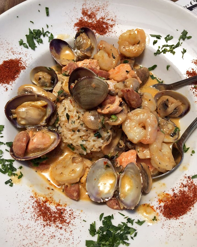 The seafood jambalaya arrives like a treasure chest of oceanic delights—clams, shrimp, and fish nestled in a savory sauce that demands to be sopped up with bread.