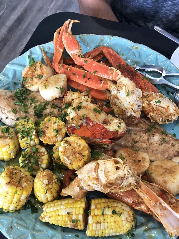 The seafood platter that makes sharing feel like a moral dilemma. Those crab legs, corn, and scallops are having a party, and everyone's invited—though you might not want to extend the invitation.