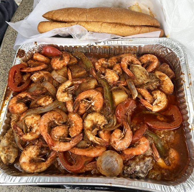 A seafood fiesta in a foil pan! These spicy, saucy shrimp swimming with peppers and onions are what happens when the ocean meets New Orleans in California.