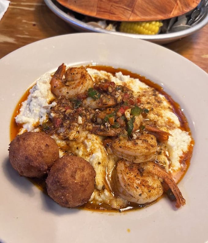 Shrimp and grits with hushpuppies standing guard—Southern comfort food elevated to an art form that grandmothers everywhere would applaud.