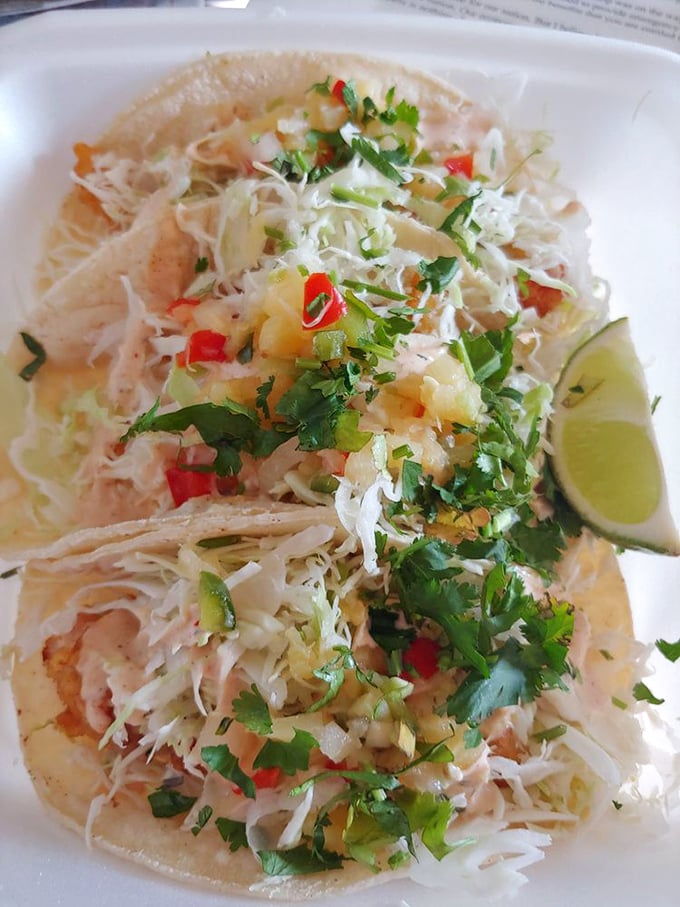These fish tacos are poetry on a plate – crispy battered fish, crunchy cabbage, zesty pico, and that signature white sauce create the perfect bite every time.
