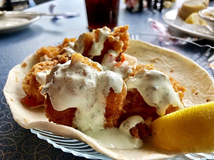 Crispy fried shrimp nestled in a shell and drizzled with creamy sauce—proof that sometimes the simplest pleasures deliver the biggest smiles.