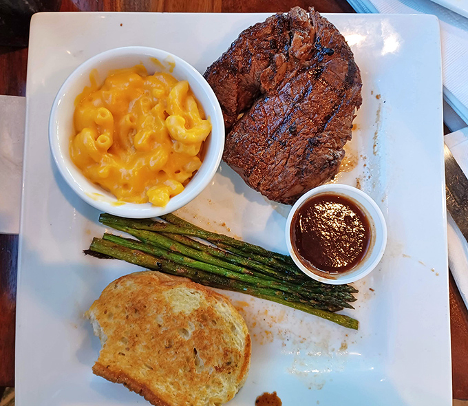A perfectly cooked sirloin with mac and cheese and asparagus—the holy trinity of steakhouse satisfaction that speaks to both your inner child and sophisticated adult.