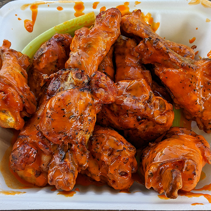 These buffalo wings aren't flying anywhere except straight to your mouth. Glossy, saucy perfection that demands sticky fingers.
