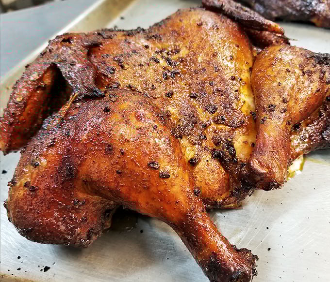 This smoked chicken wears its spice rub like a well-tailored suit – perfectly fitted to enhance every bite with a complex, smoky character.