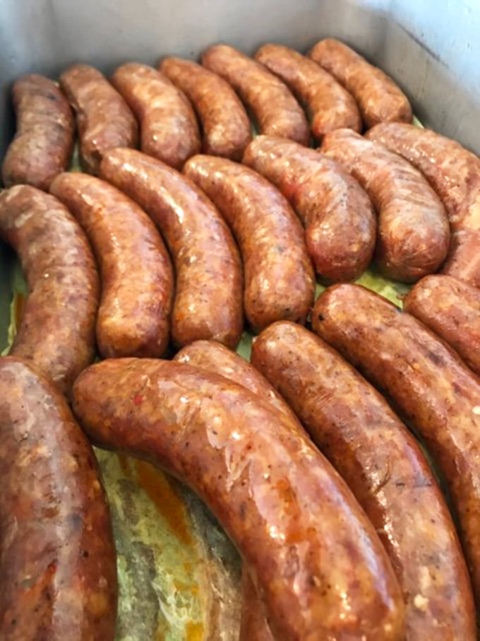 These sausages aren't just cooking—they're sunbathing in their own delicious juices, waiting to snap between your teeth with smoky perfection.