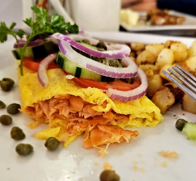 This omelet doesn't just contain salmon—it showcases it. With those fresh vegetables and perfect fold, it's breakfast elevated to an art form.