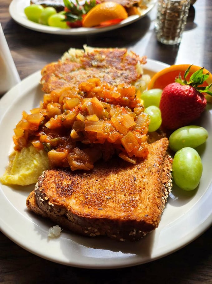 This isn't just breakfast—it's edible art. Caramelized onion compote crowns perfectly toasted bread alongside fresh fruit for a symphony of sweet and savory.