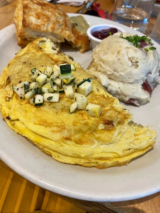 This omelet doesn't just sit on the plate—it tells a story of seasonal vegetables that volunteered as tribute for your breakfast pleasure.