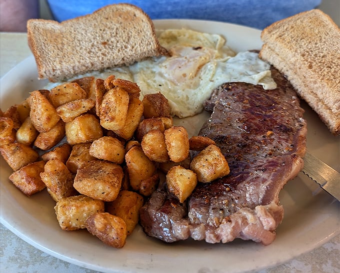 The classic steak and eggs—when you can't decide between breakfast and dinner, so you have both. Those home fries are the supporting actors who steal the show.