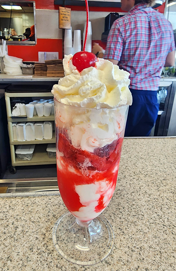 The strawberry sundae stands tall and proud like a dessert skyscraper—layers of sweet architecture that makes spoons weak at the handle.
