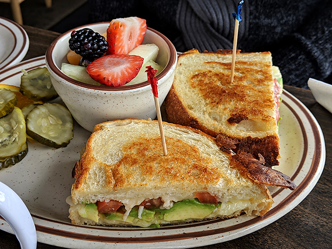 This sandwich isn't just grilled cheese – it's a masterclass in balance. Crispy exterior, melty interior, fresh accompaniments.