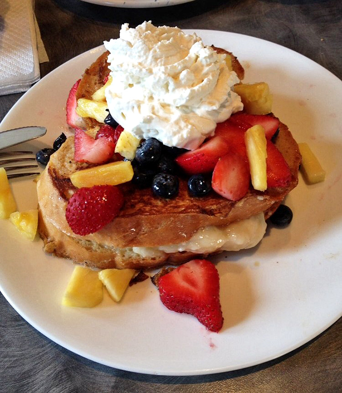 French toast living its best life, adorned with a berry jewelry collection and whipped cream tiara. Breakfast royalty that makes ordinary toast hang its head in shame.