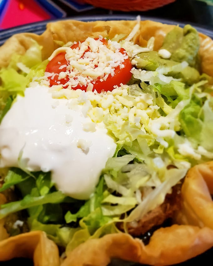 This taco salad bowl doesn't just hold ingredients—it cradles them. The crispy tortilla shell creates the perfect vessel for that mountain of freshness inside.