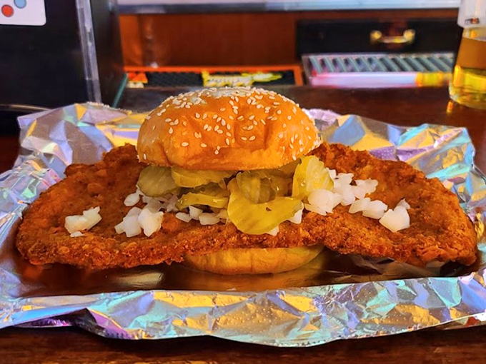 The tenderloin-to-bun ratio here is hilariously perfect—like wearing a king-sized comforter as a cape. Those pickles and onions aren't garnish; they're essential counterpoints.