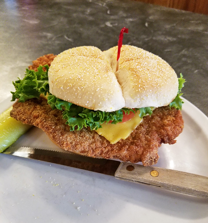 This breaded tenderloin sandwich has clearly never heard the phrase "bigger isn't always better" and we're absolutely fine with that.