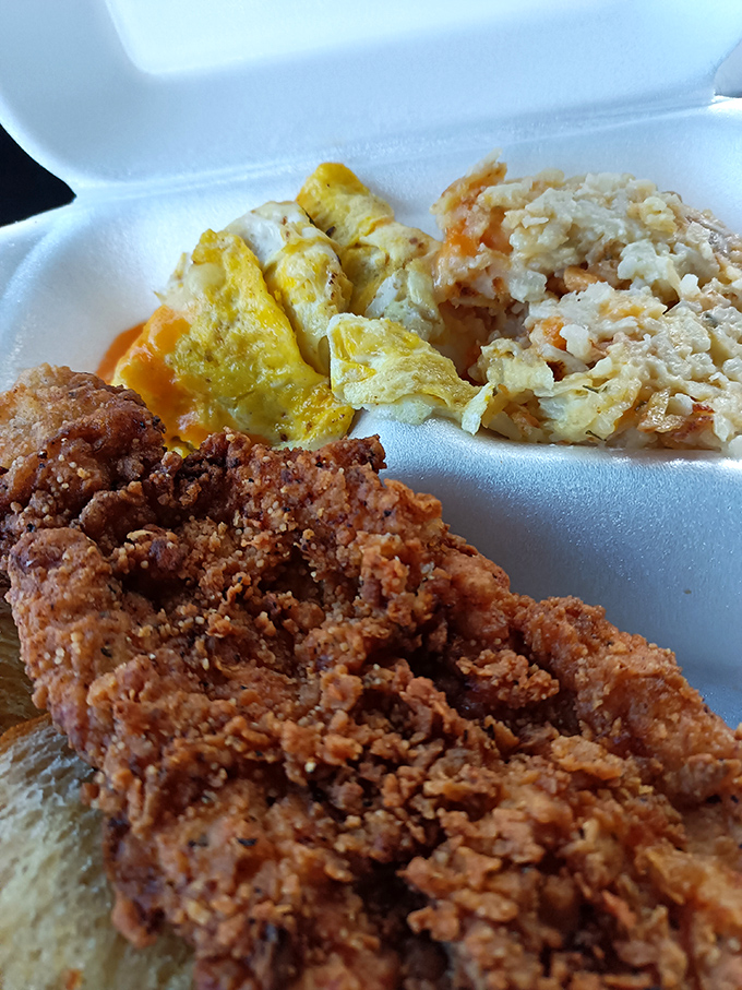 This breakfast feast features eggs, home fries, toast, and what appears to be a chicken-fried delight topped with that legendary gravy.