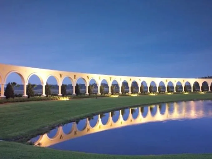 The arched colonnade stretches along the water like a Roman aqueduct that decided retirement in Florida was its well-deserved reward.