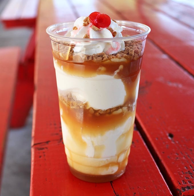 Layers of vanilla, caramel, and toffee crunch create a parfait that's basically therapy in a cup. No couch required.