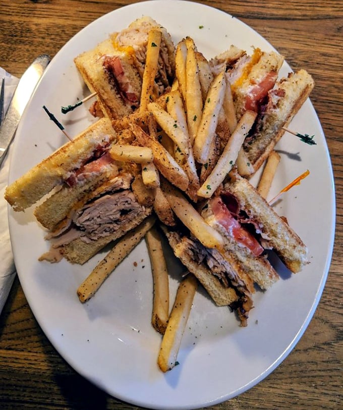 The club sandwich—architecture you can eat. Stacked higher than your weekend to-do list but infinitely more satisfying to tackle.