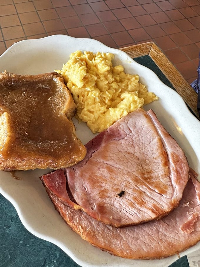 Breakfast perfection doesn't need fancy plating—just perfectly cooked eggs, thick-cut ham, and homemade toast that makes store-bought bread seem like a sad compromise.