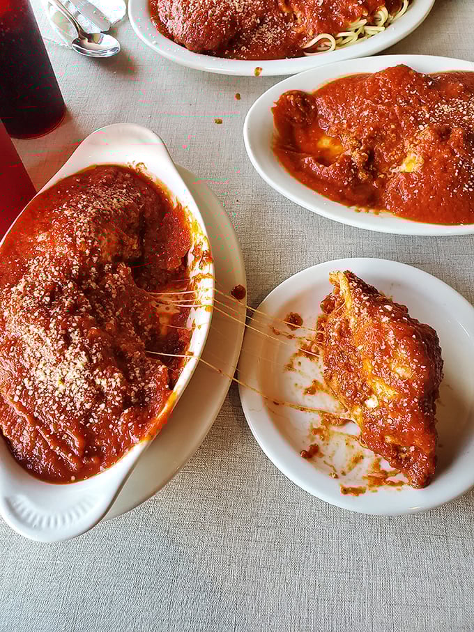 A table full of pasta perfection—where the cheese pull is Olympic-worthy and the marinara sauce could make a cardboard box taste delicious.