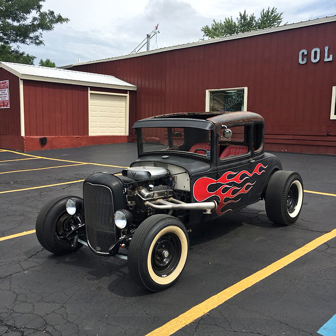 Hot rod heaven in the parking lot! This flame-adorned beauty isn't just transportation—it's rolling sculpture with attitude to spare.