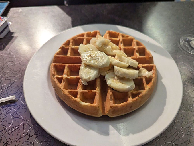 Waffles aren't just for breakfast—they're an all-day canvas for whatever toppings your heart desires. This banana-topped version is simplicity perfected.