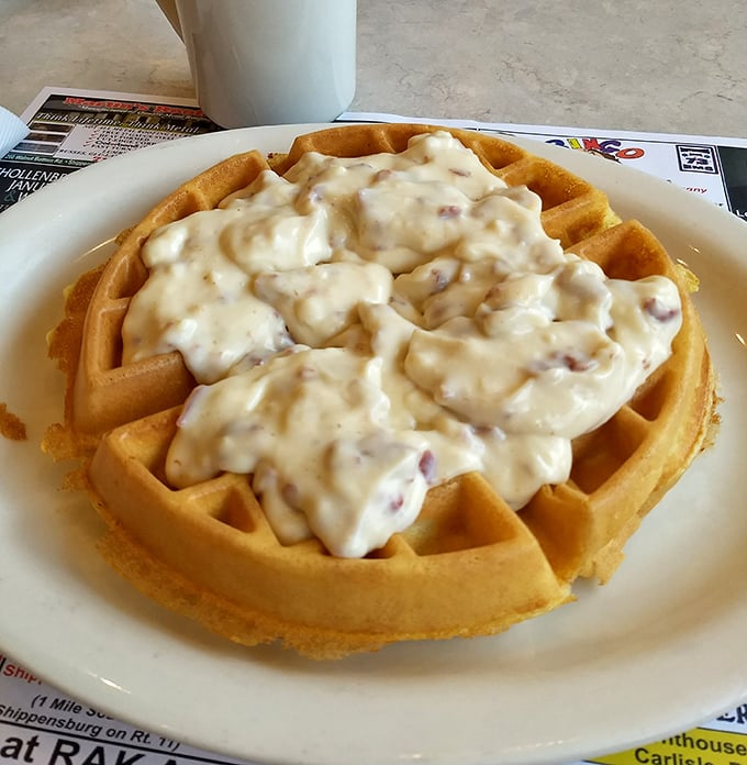 This Belgian waffle smothered in sausage gravy isn't just breakfast—it's a declaration that today is going to be extraordinary, calories be darned.