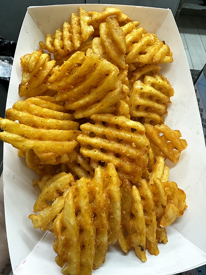 Not just fries—an architectural marvel of potato. These waffle-cut beauties offer maximum surface area for seasoning and maximum pleasure for eating.