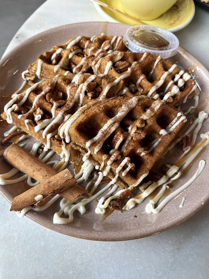 These cinnamon-dusted waffles with their artful drizzle of sweetness are what breakfast dreams are made of – no snooze button needed.