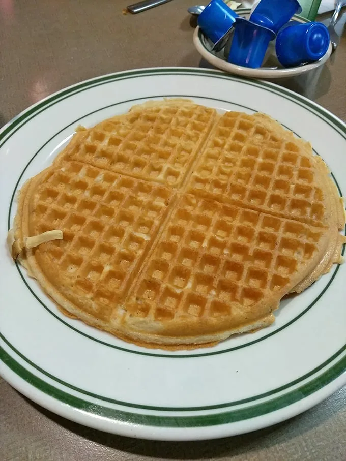 The waffle that launched a thousand breakfasts—golden, crisp-edged perfection waiting for its maple waterfall. Simple pleasures are often the most profound.